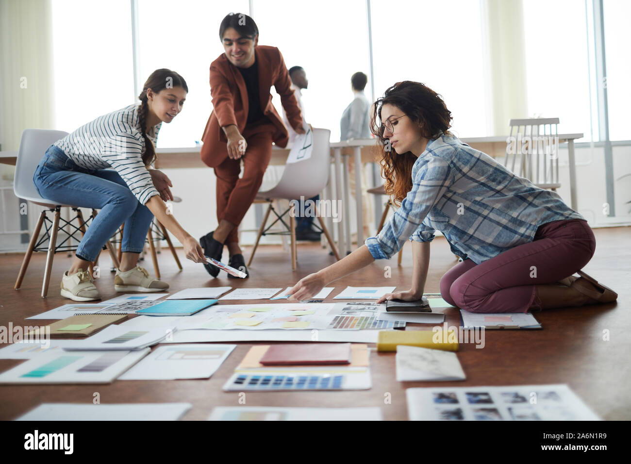 Portrait of creative business team working on design project with ...
