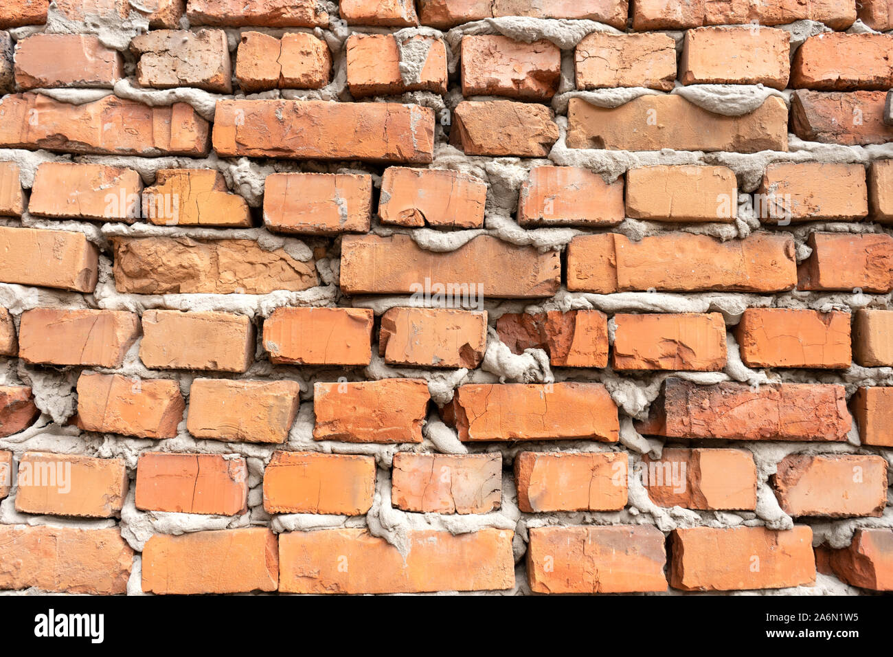old red brick falling apart wall texture background Stock Photo - Alamy