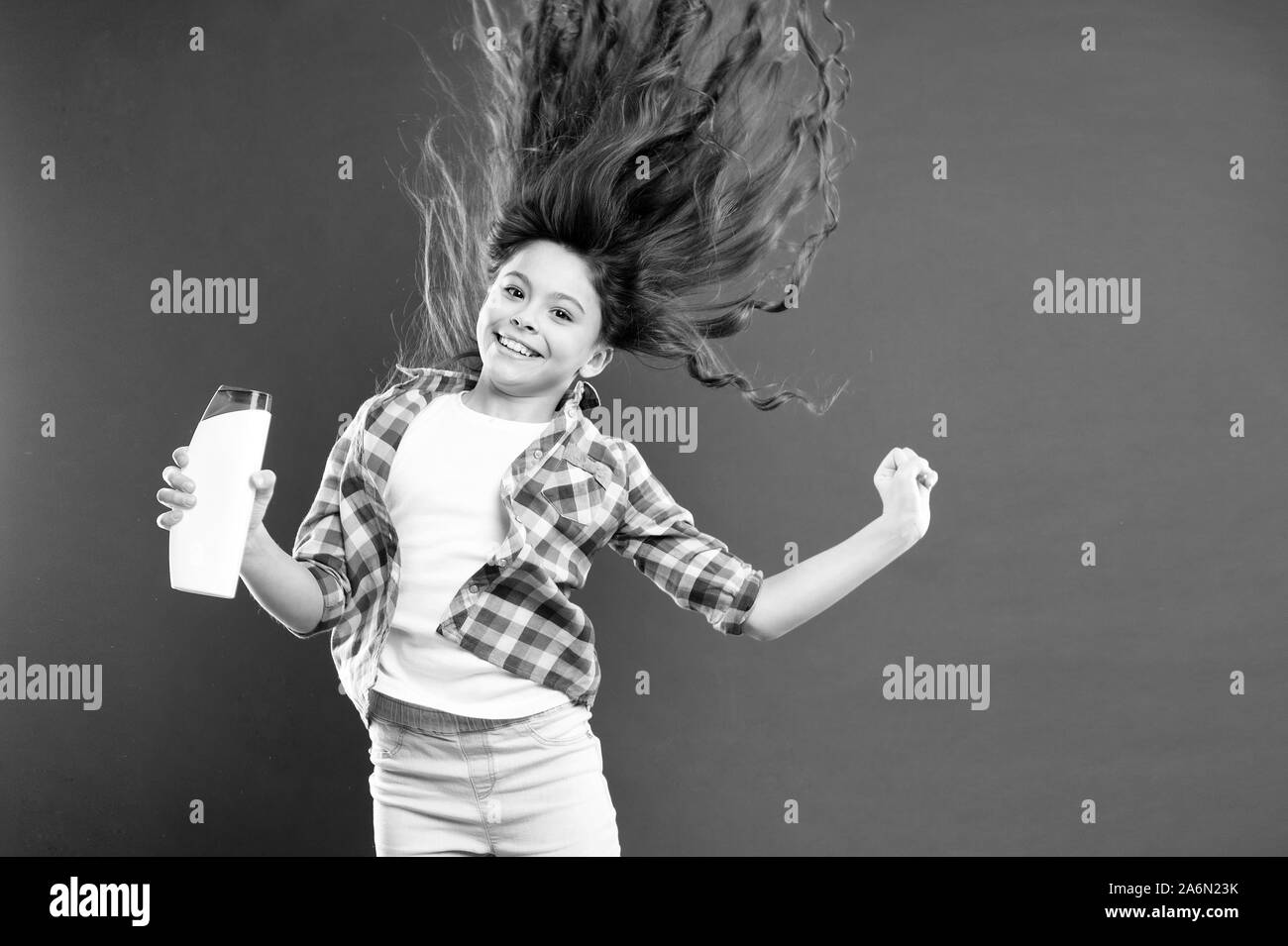 Getting more hair can be simple. Happy child jumping with hair shampoo ...