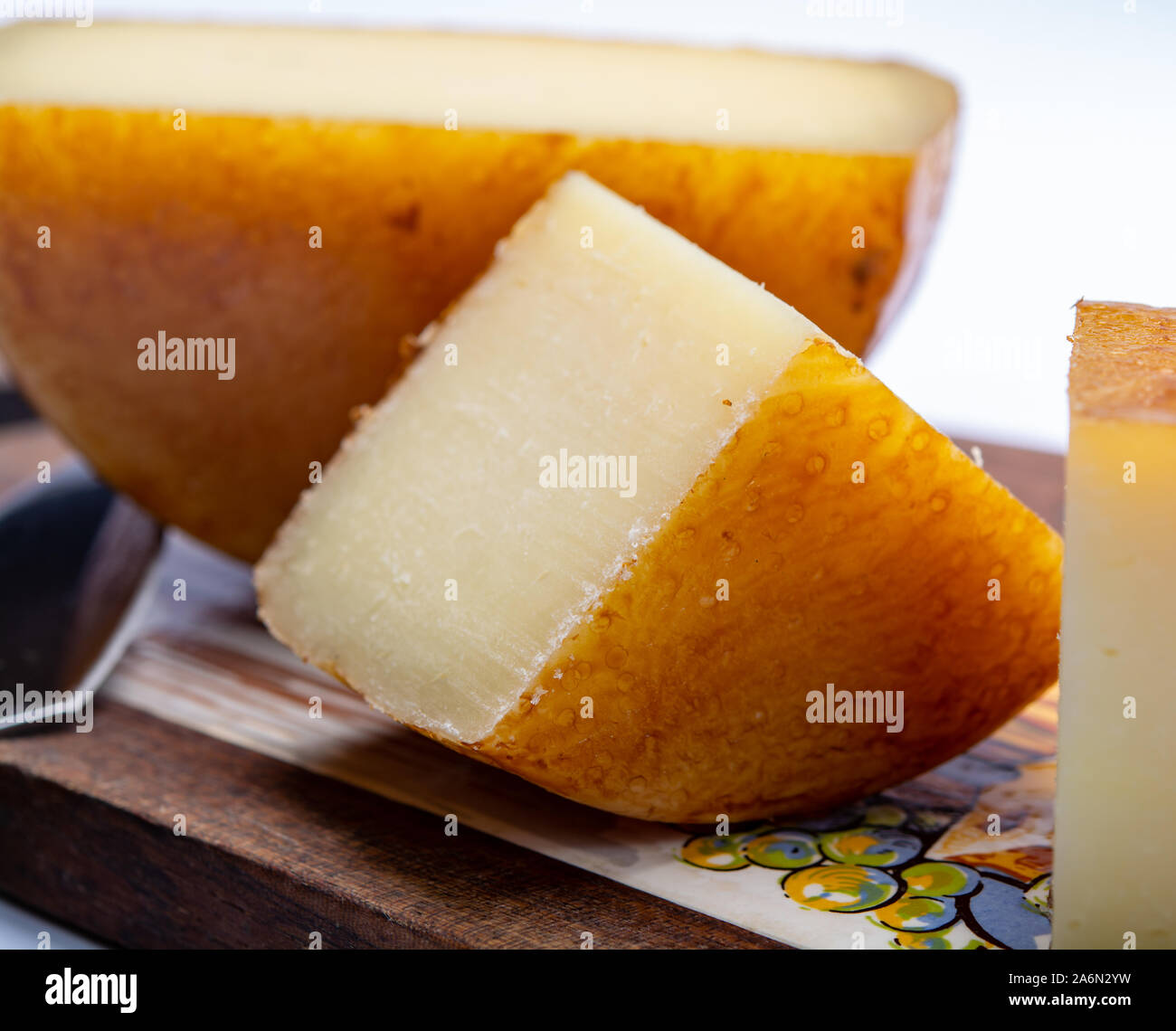 Hard Italian pecorino sheep cheese on wooden board close up isolated ...