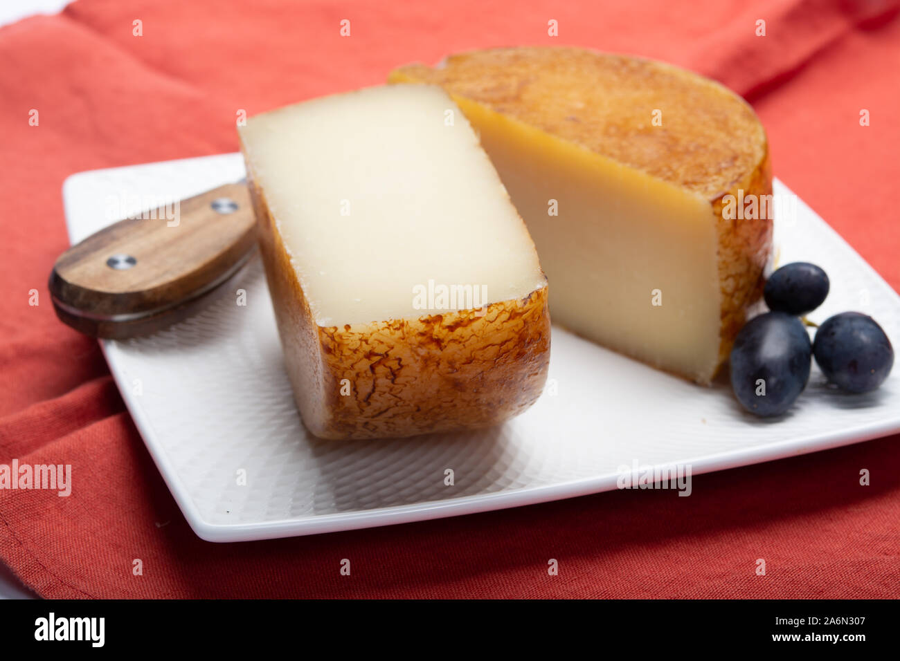 Hard Italian pecorino sheep cheese in two pieces close up isolated ...
