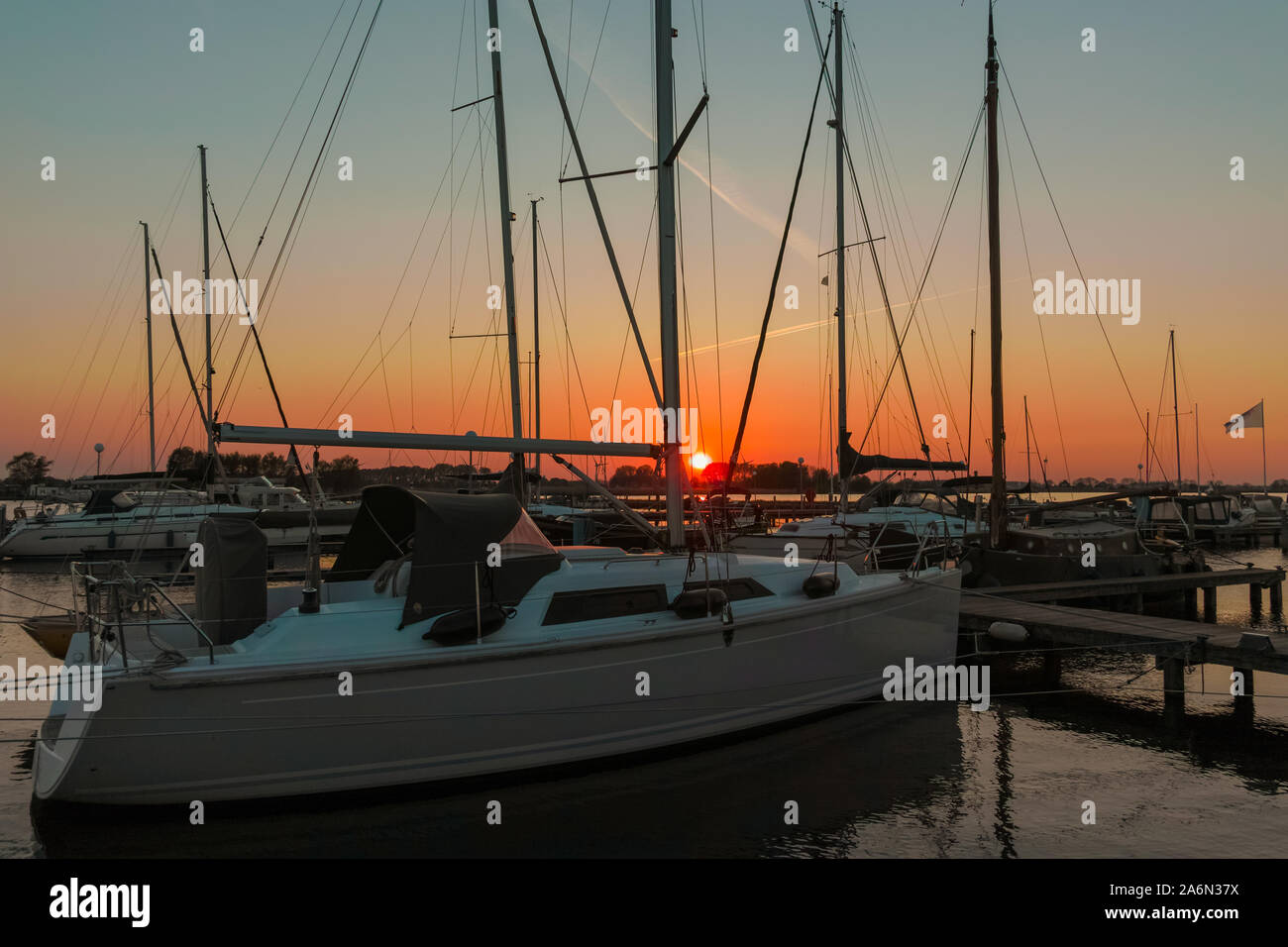 Sunset in yacht club with sailboats on water, landscape photo Stock ...