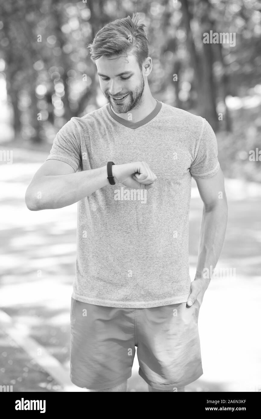 Best for training. Sportsman tracking his training with a sports watch ...