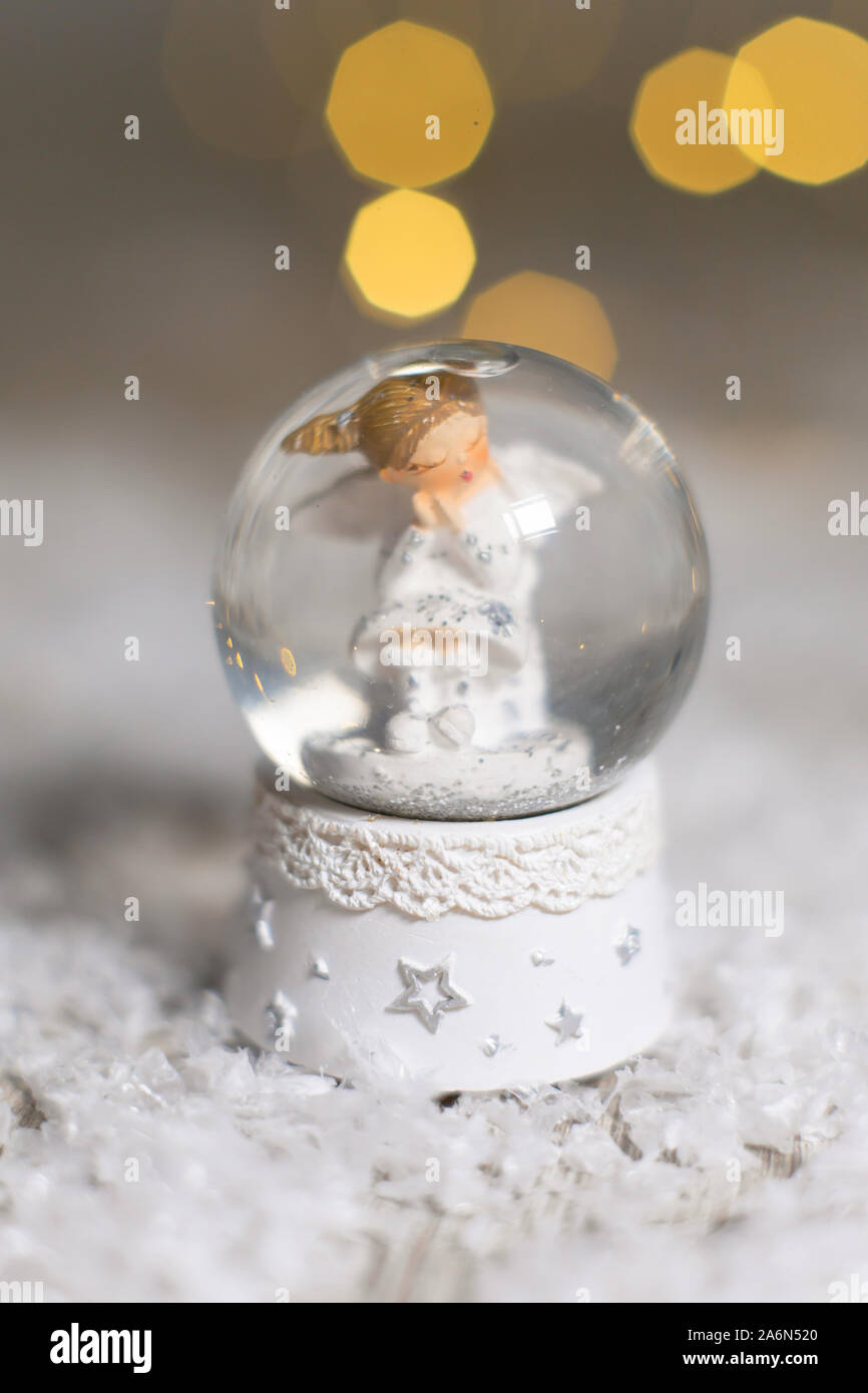 Decorative Christmas-themed figurines. Glass ball with snowflakes in ...