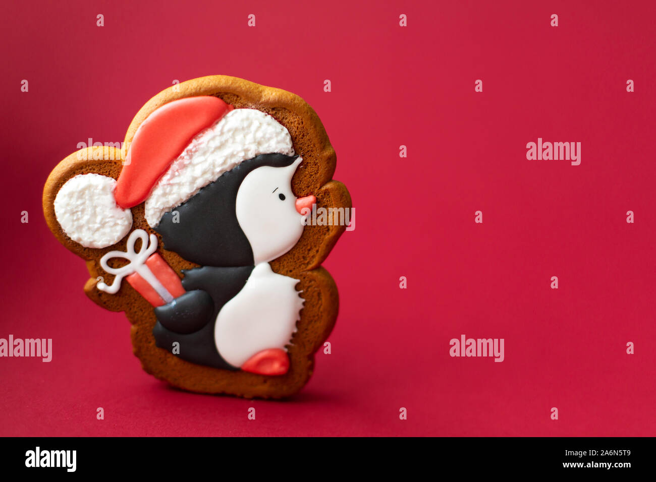 gingerbread cookie of cute penguin on red background. Traditional ...