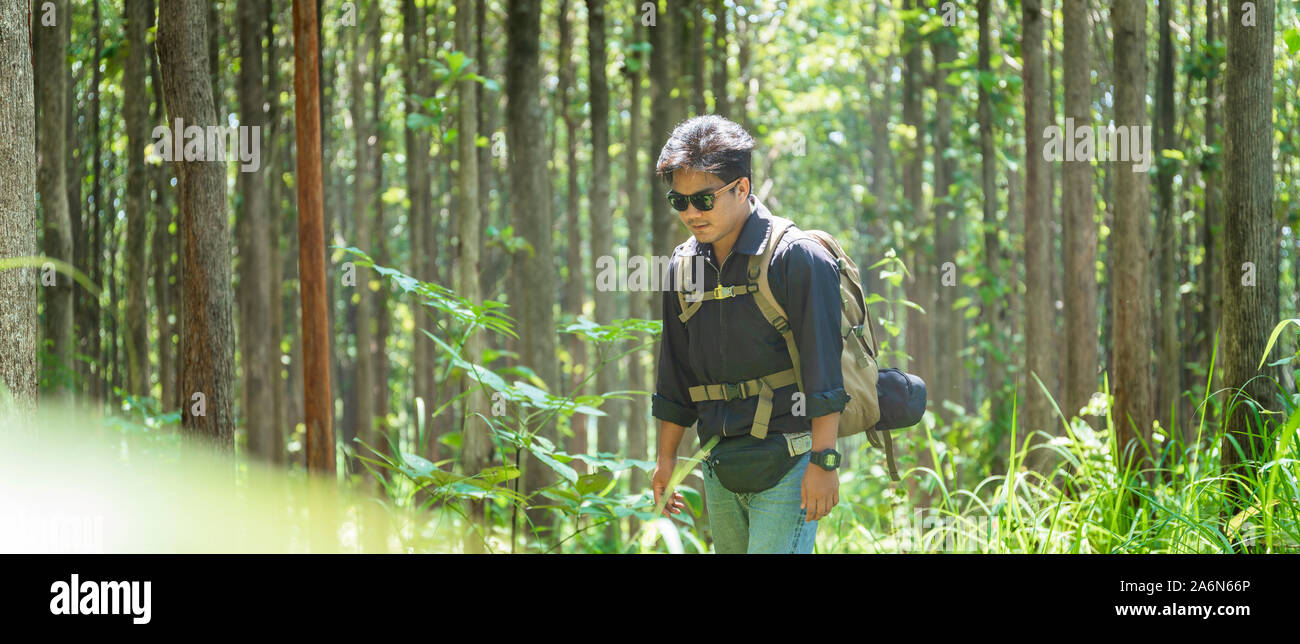 Man walking alone in deep forest Travel healthy active lifestyle ...