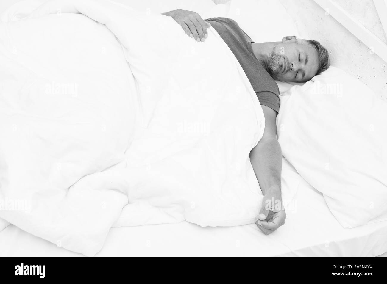 Healthy habits. Man handsome guy lay in bed sleeping. Get enough amount ...