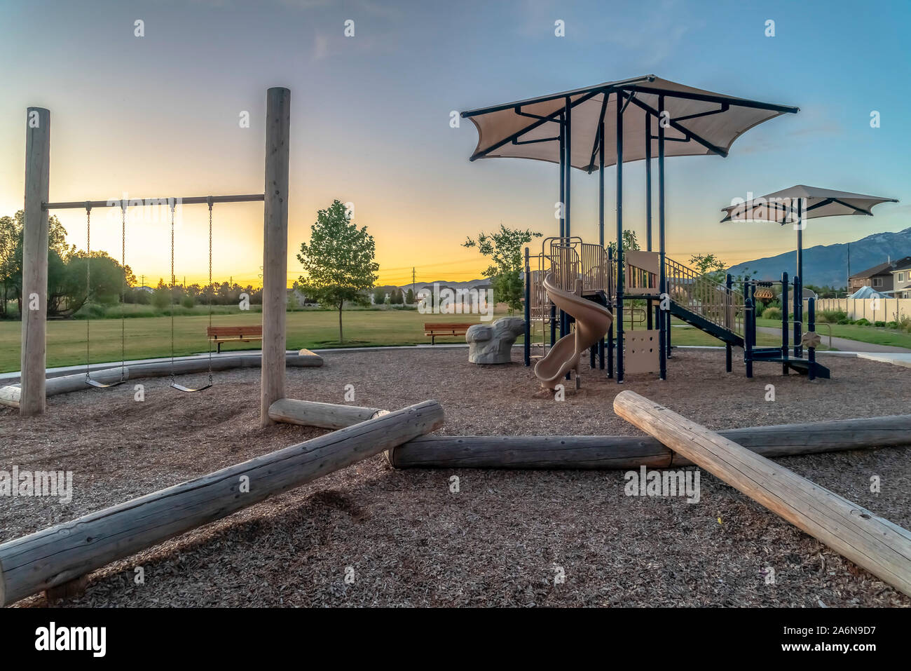 Neighborhood park with fun playground featuring slides and swings for ...