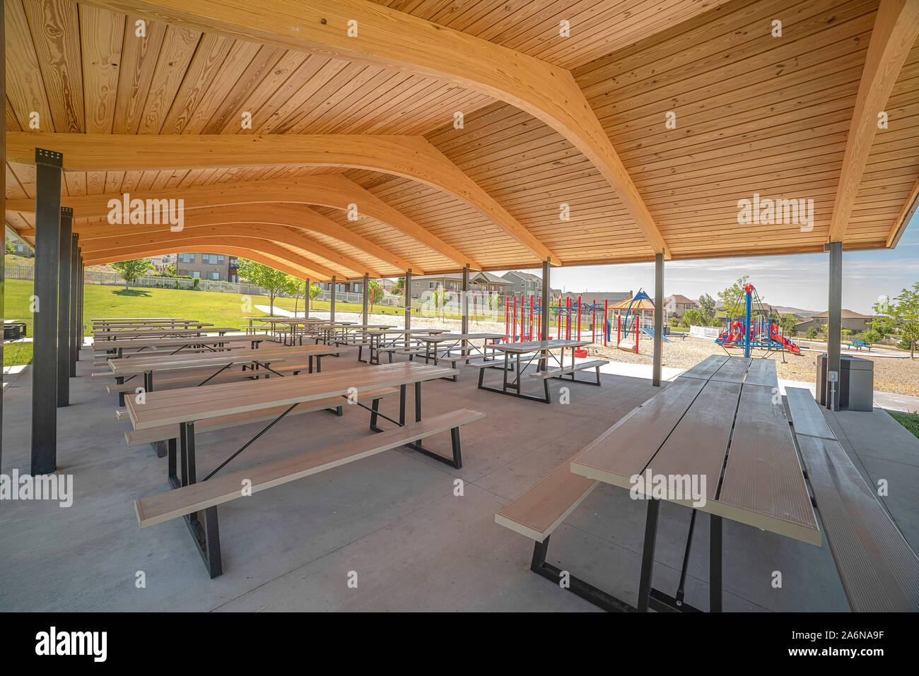 Pavilion at a park with view of colorful playground equipment and ...