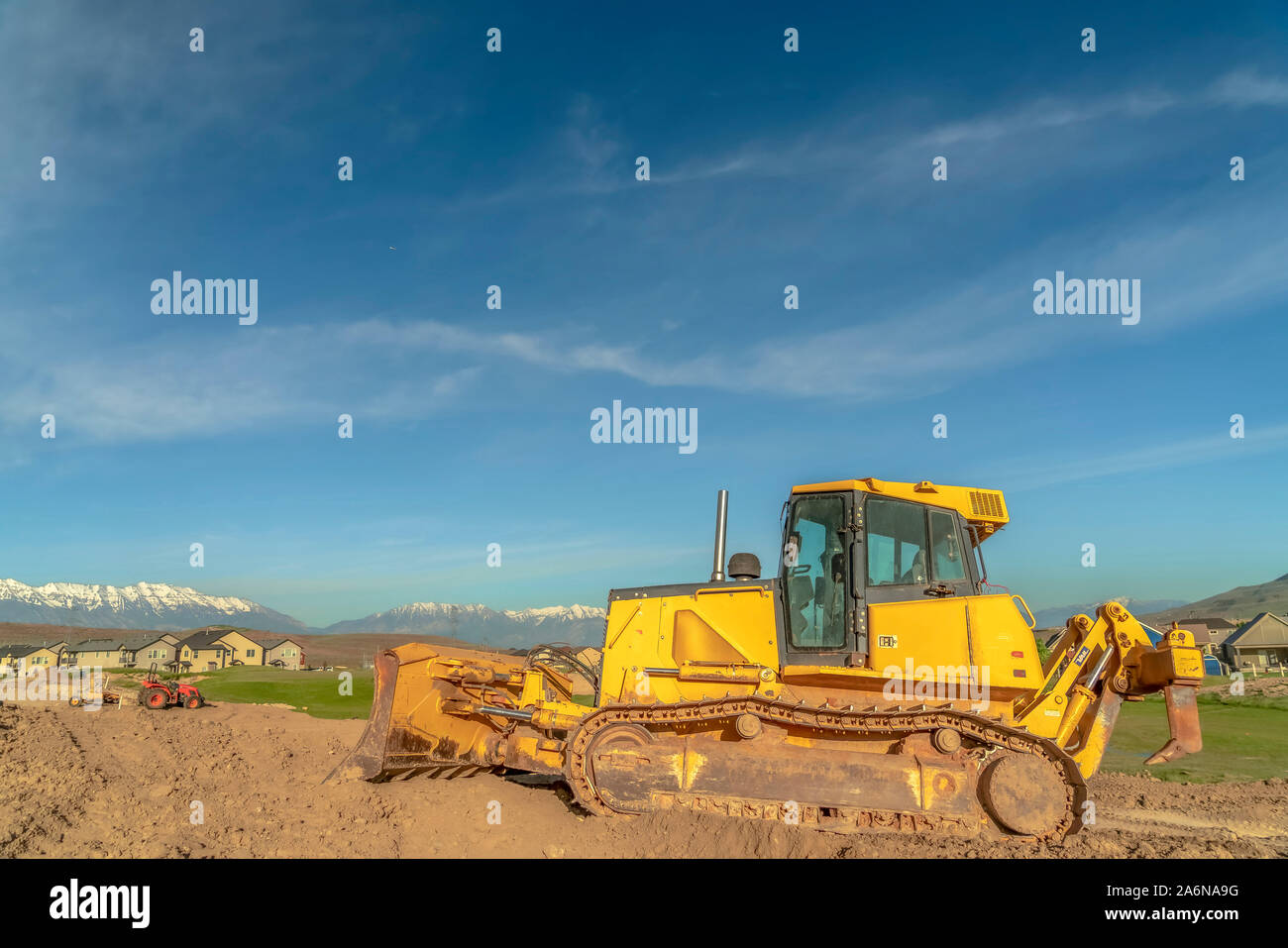 Yellow bulldozer with tracks and a blade used for pushing construction ...