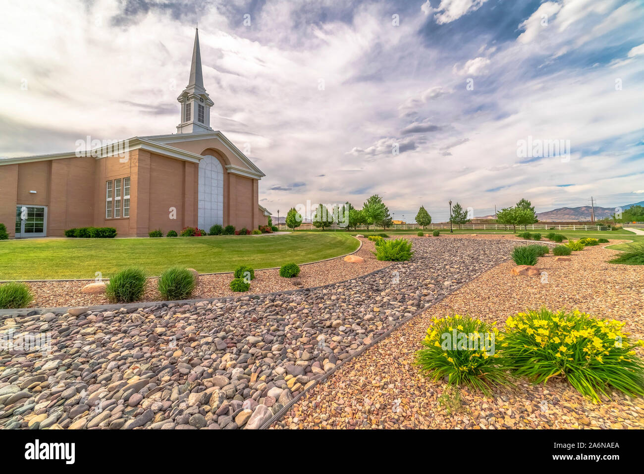Sunny day view with cloudy sky over church with steeple and large ...