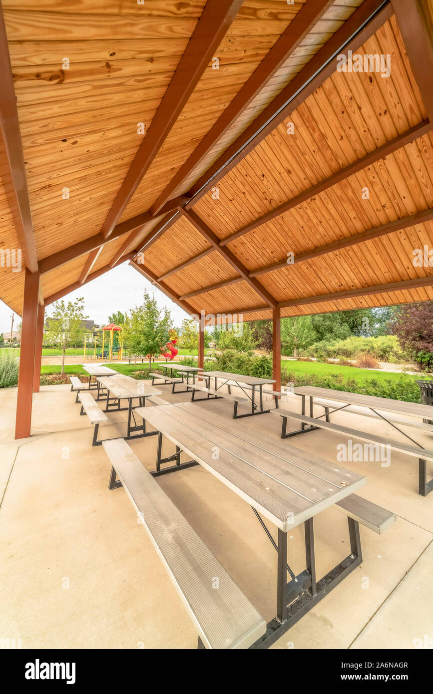 Close up of the tables and seats under the brown wood ceiling of a ...