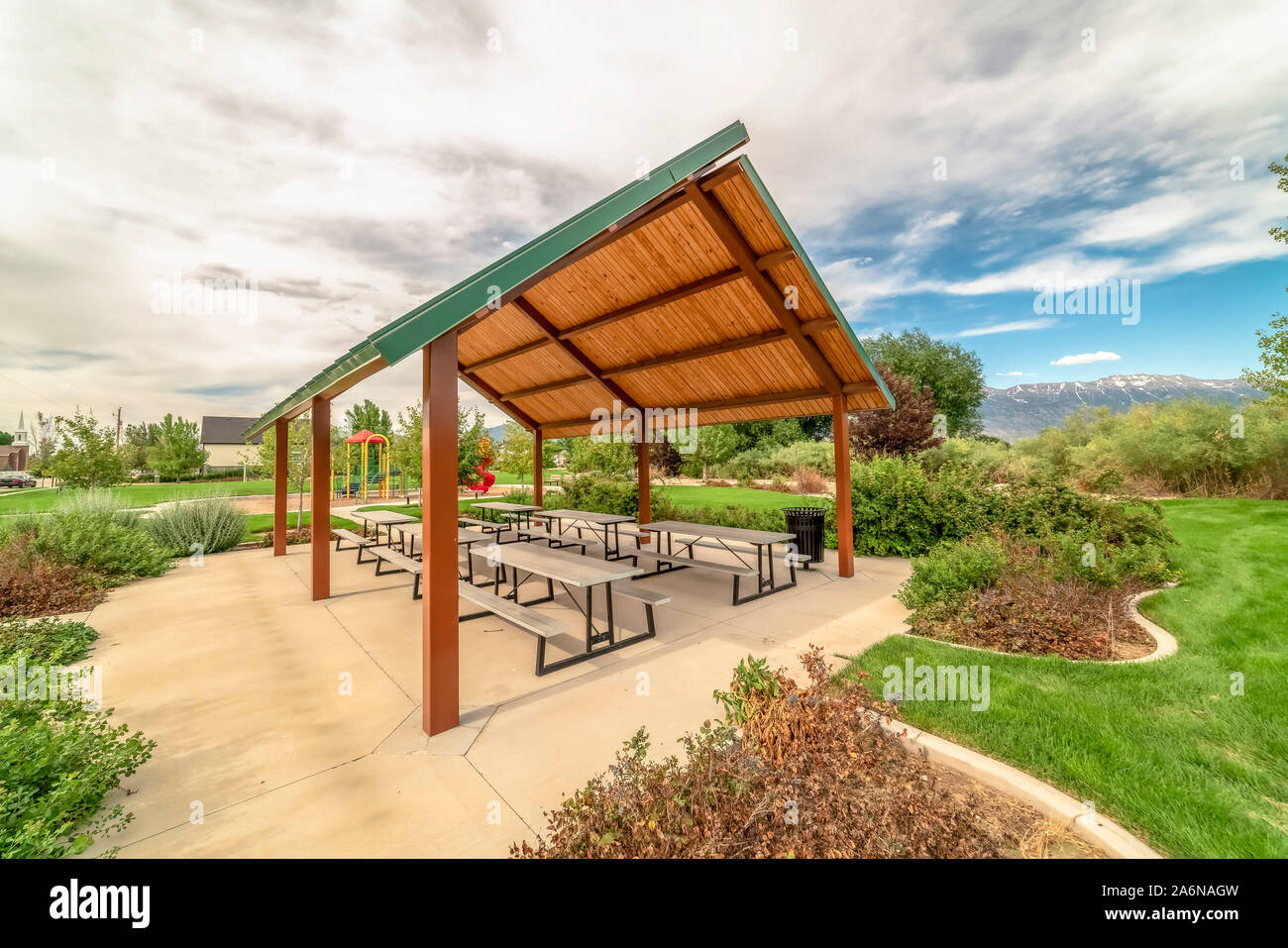 Pavilion at a park with colorful playground and mountain in the ...