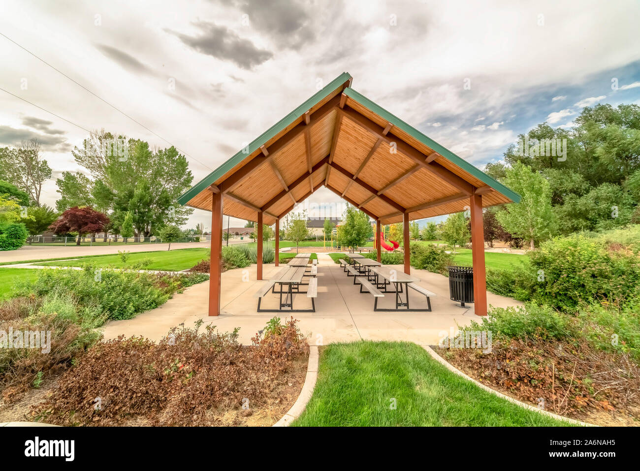 Beautiful scenery at a park with focus on a pavilion with tables and ...