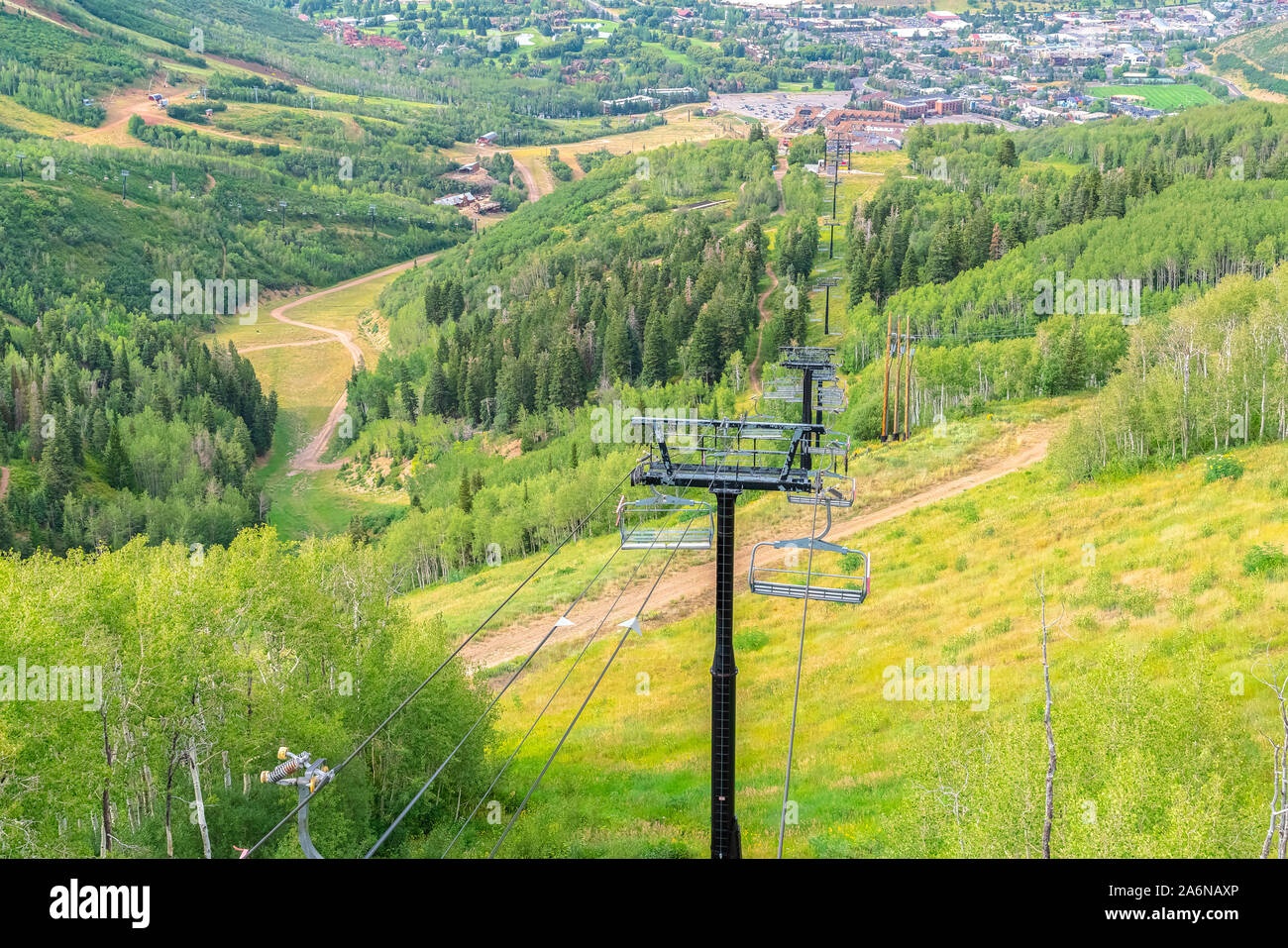 Chairlifts with amazing view of ski resort blanketed in greenery at off ...
