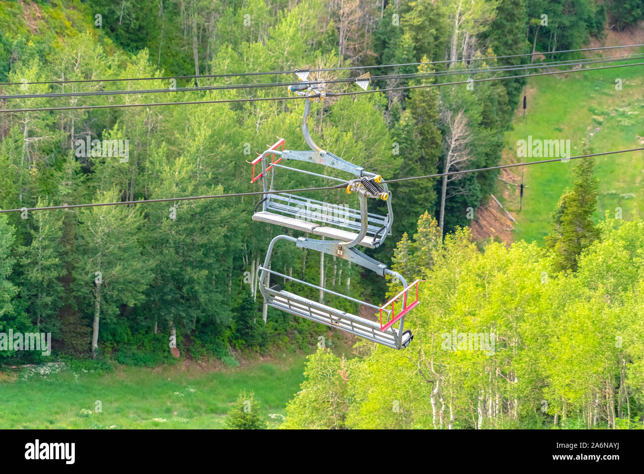 Chairlifts with aerial view of ski resort covered in greenery during ...