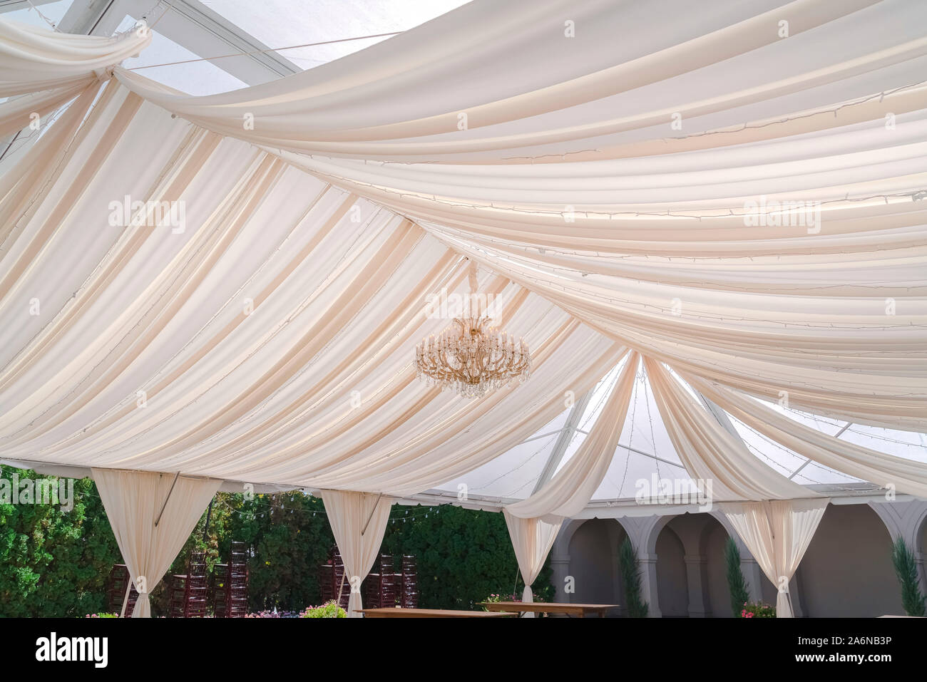 Stunning wedding venue with white canopy and curtains under the glass ...