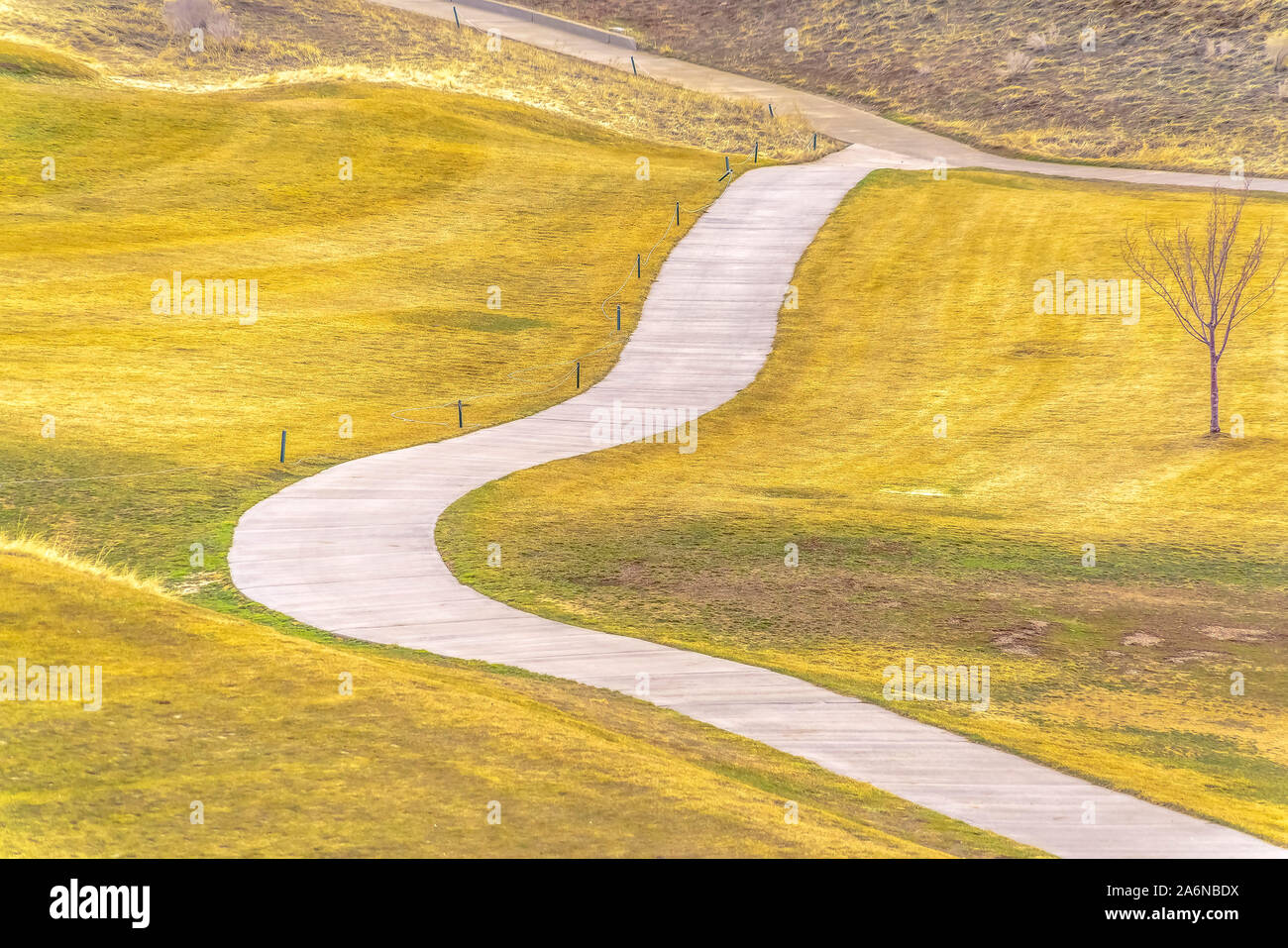 Footpath or cycle path winding over rolling hills Stock Photo - Alamy