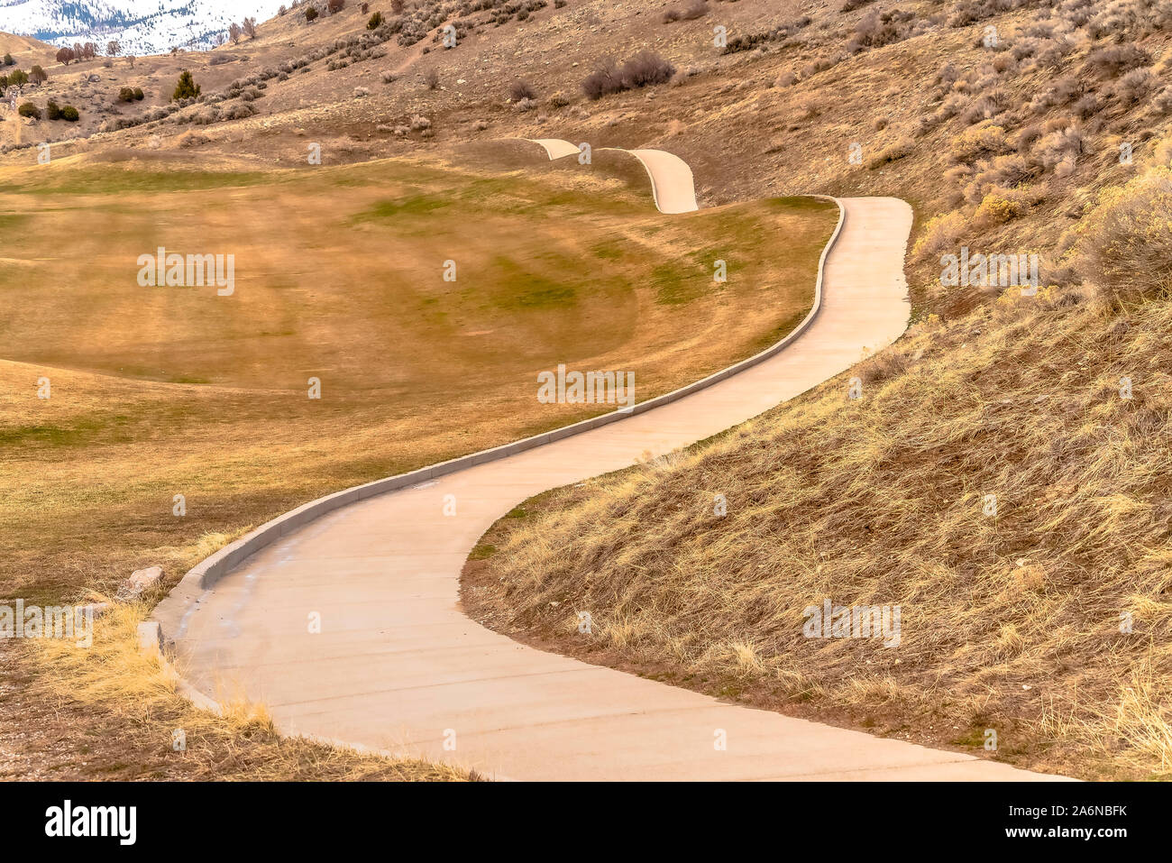 Winding narrow rural road through foothills golf Stock Photo - Alamy