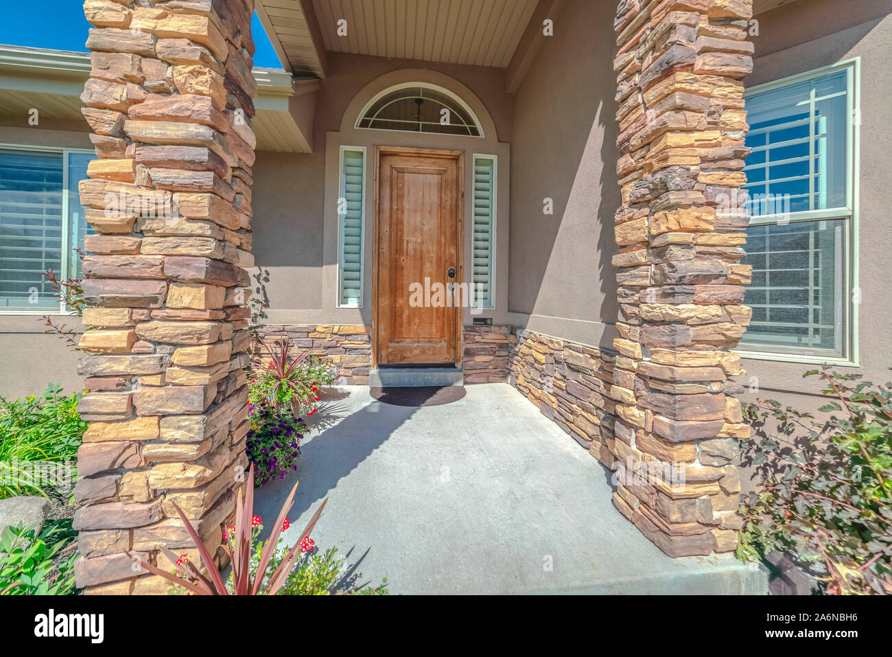 Front porch and door of house with stone pillars Stock Photo - Alamy