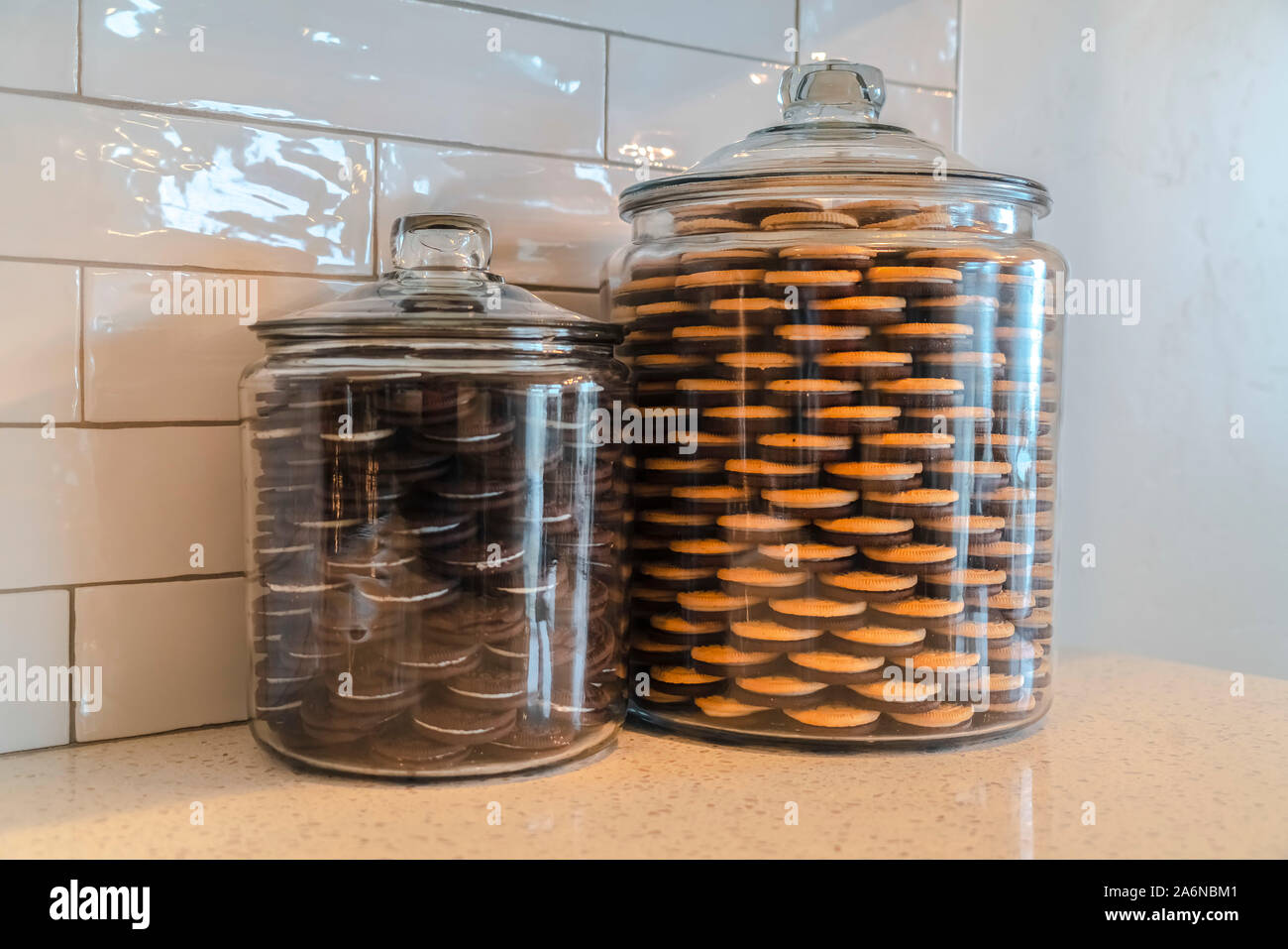 Two large glass storage jars filled with cookies Stock Photo - Alamy