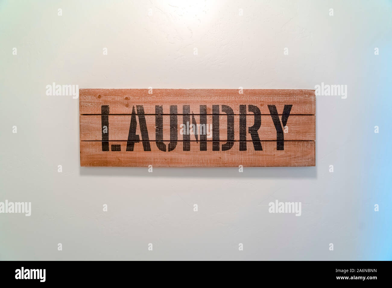Painted wooden Laundry sign on white wall Stock Photo - Alamy