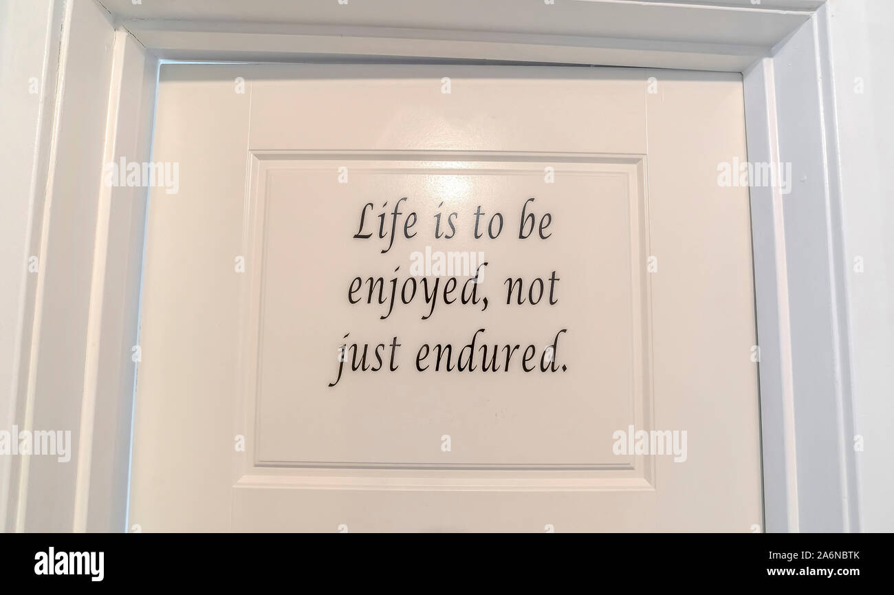 Inspirational quote on back of white home door Stock Photo - Alamy