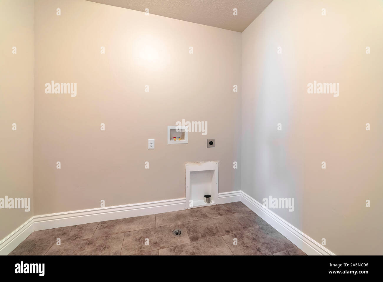 Empty laundry room with water connections empty room Stock Photo - Alamy
