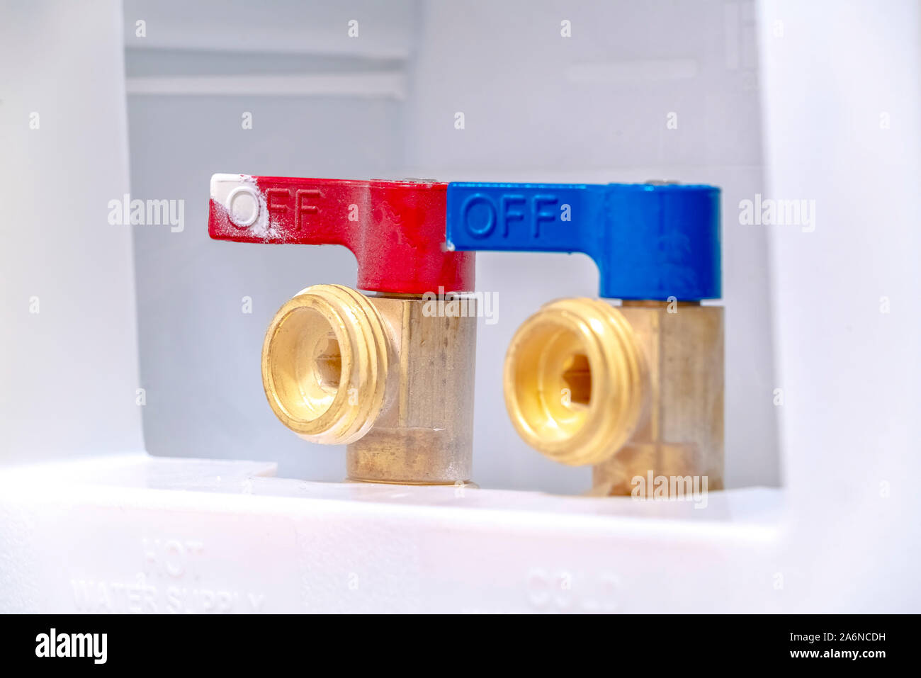 Hot and cold water inlets for a washing machine Stock Photo - Alamy