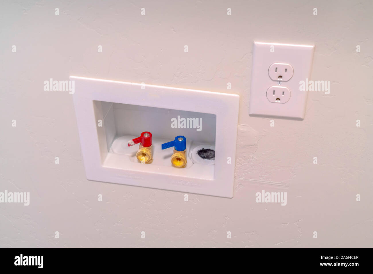 Water connectors and plugs in a laundry room Stock Photo - Alamy