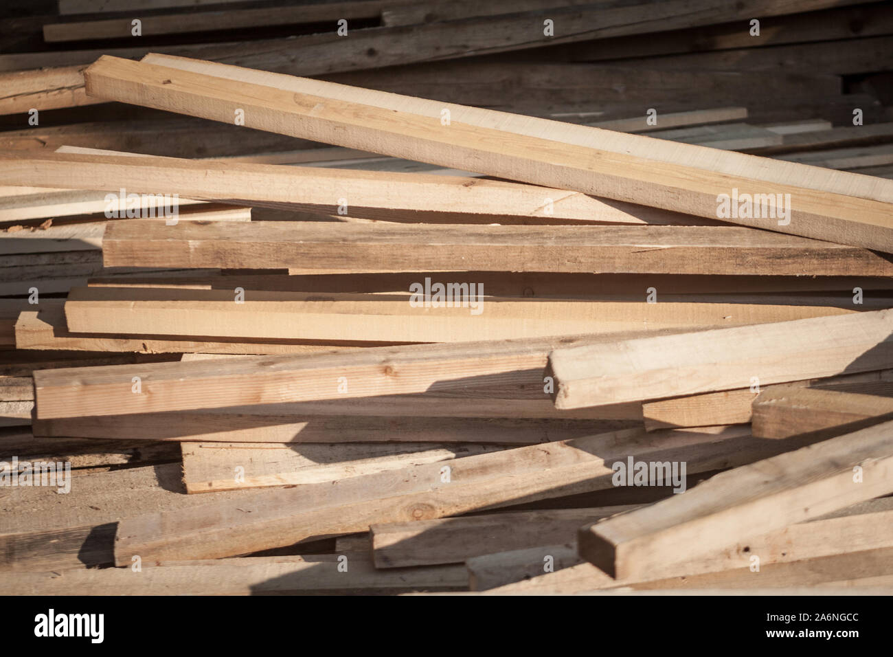 Wooden planks, rods and poles, stockes in piles and stacks, waiting to ...