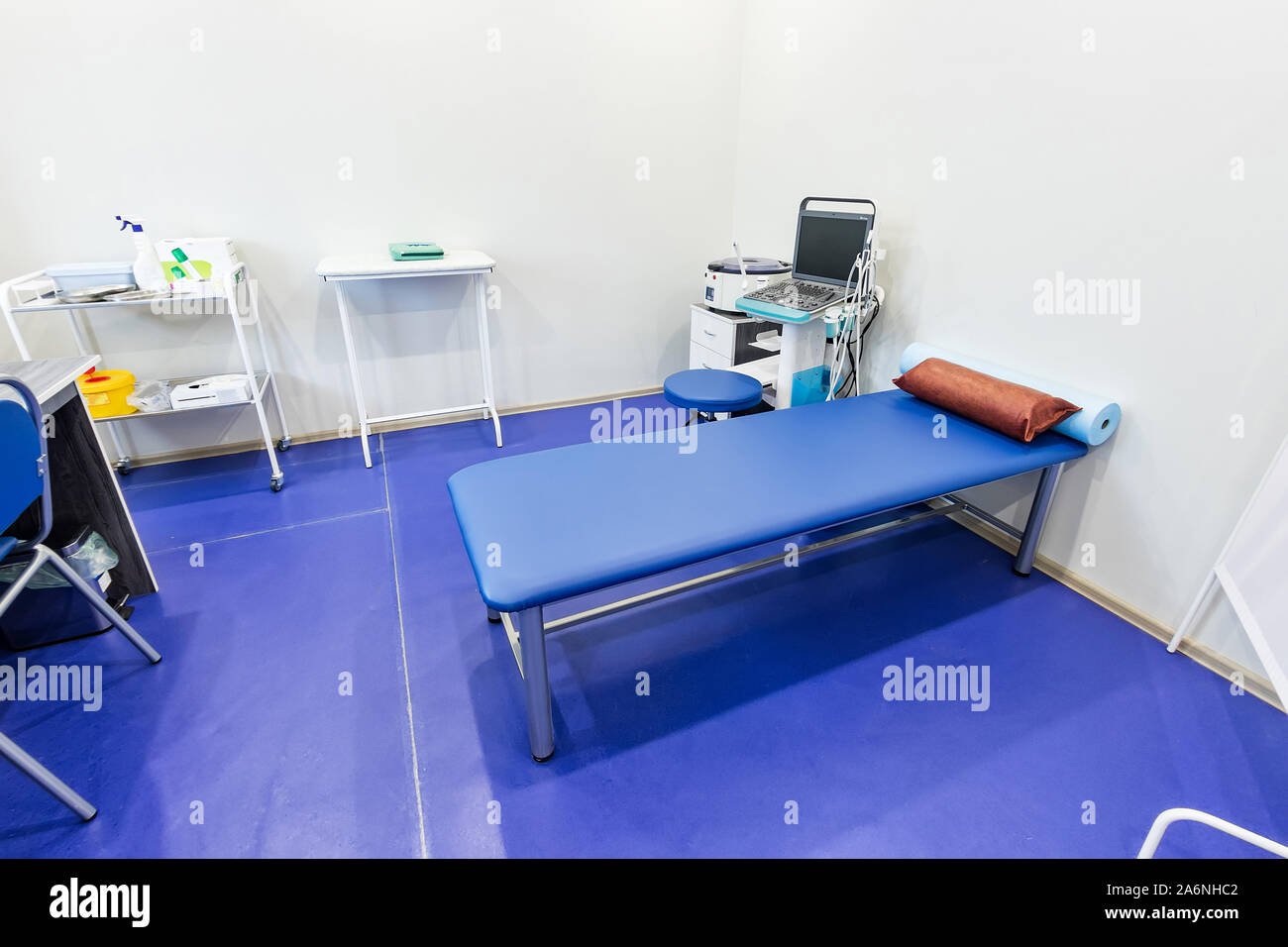 Medical office, couch with an ultrasound machine, table and computer ...