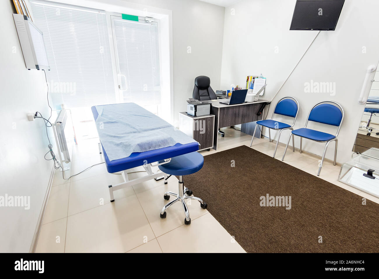Medical office, couch with an ultrasound machine, table and computer ...