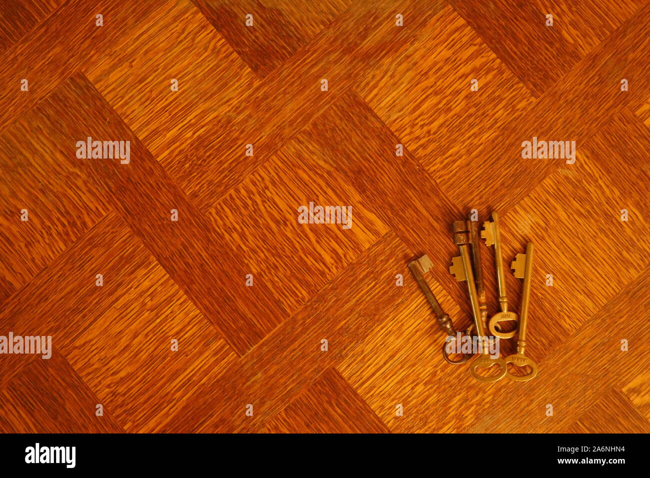 Top view, flat lay. of copper and bronze keys on wooden rustic table ...
