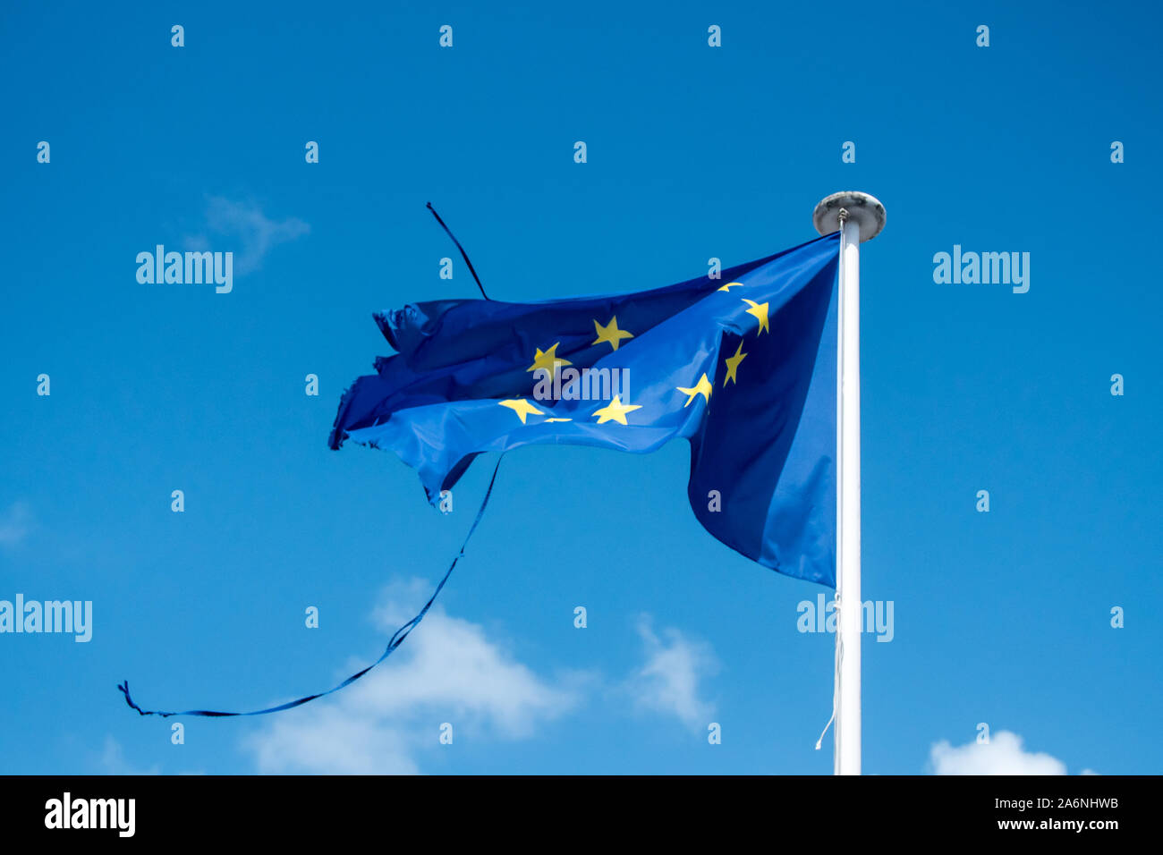 damaged European flag on pole in the air. This European flag describe ...