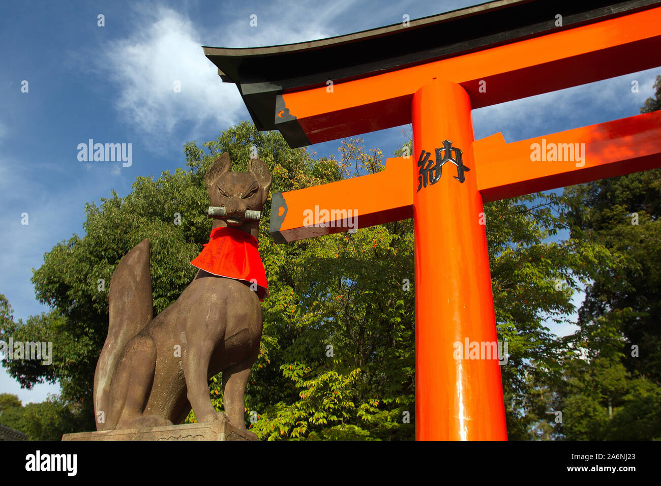 Kitsune fox figure holding scroll of knowledge in its mouth at Fushimi ...