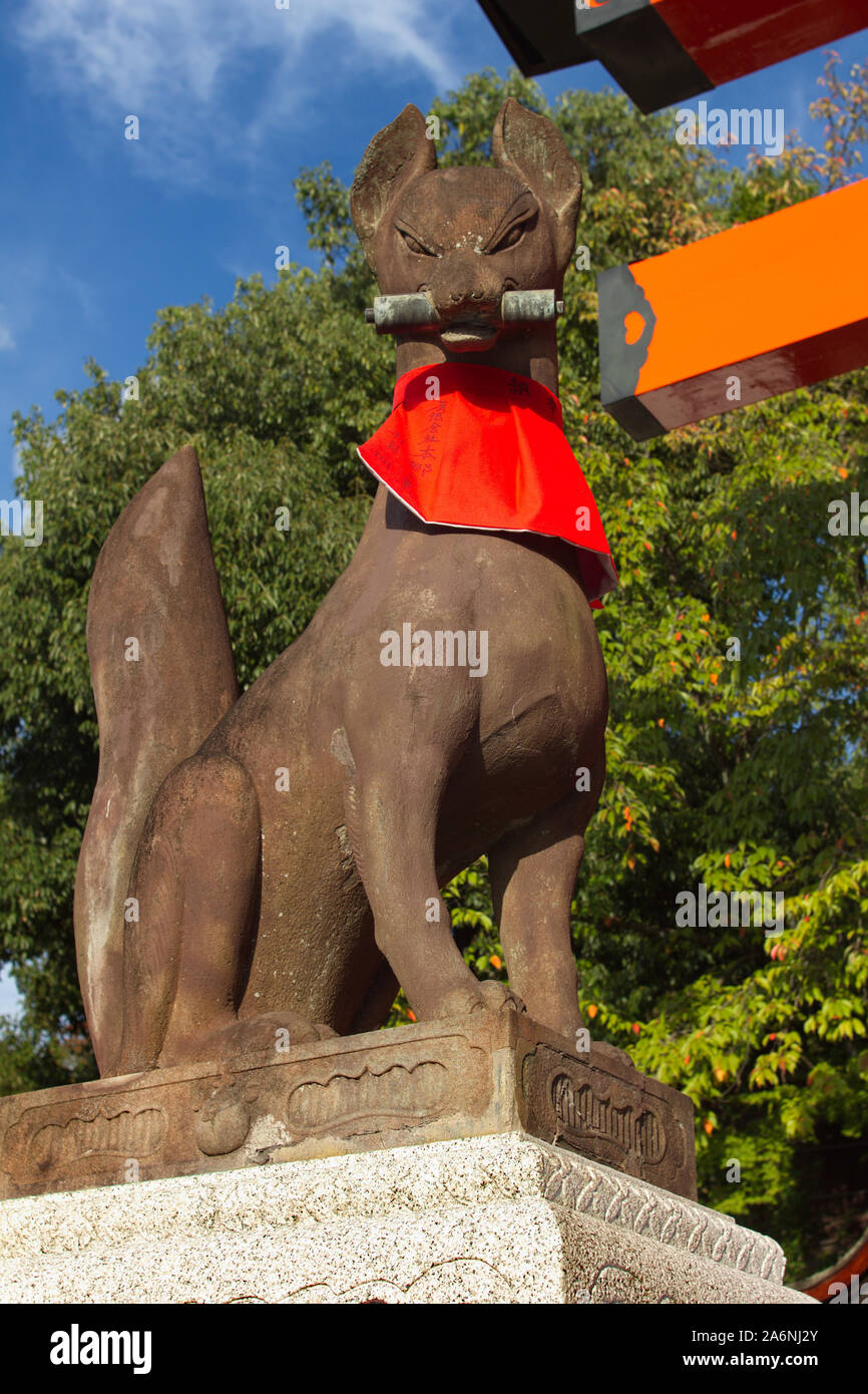 Kitsune fox figure holding scroll of knowledge in its mouth at Fushimi Inari Taisha a Shinto shrine in Kyoto Japan Stock Photo Alamy