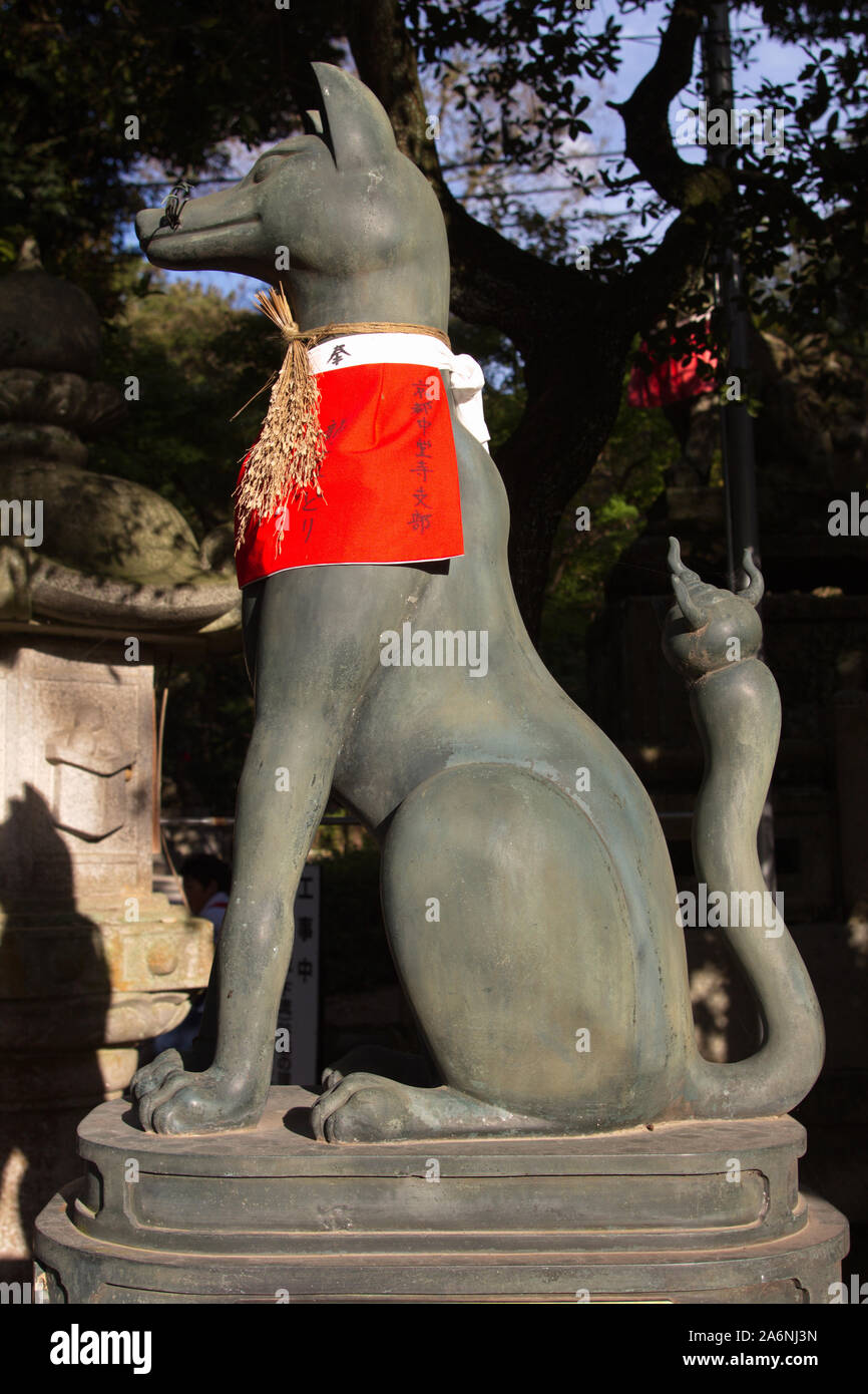 Kitsune fox figure with a sheaf of rice tied to its neck at Fushimi ...