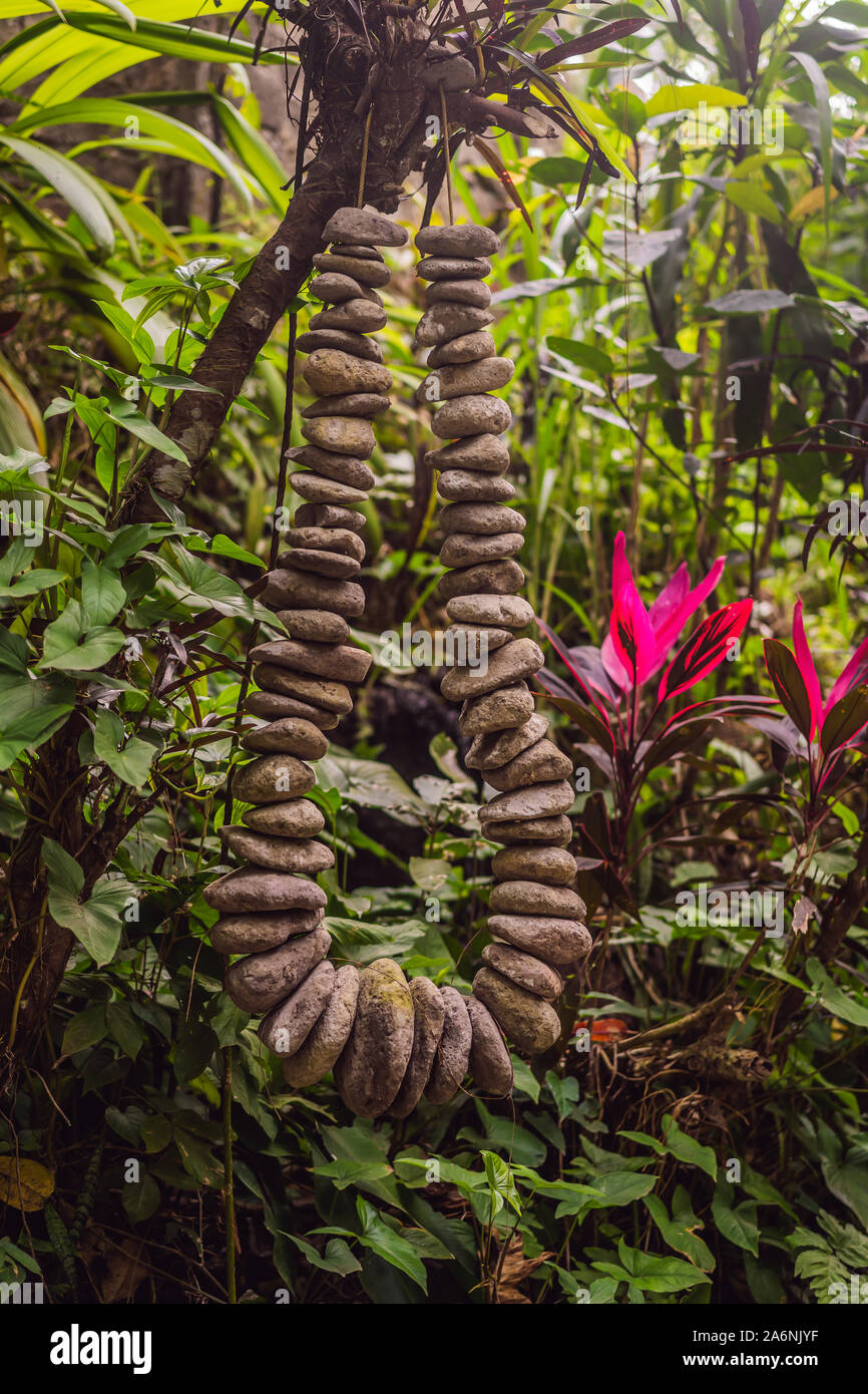 Stones strung on a rope like beads for a tree, Ubud, Indonesia Stock ...