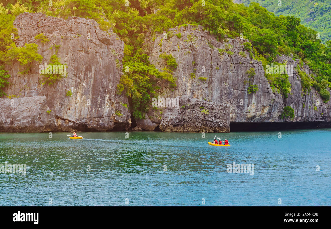 Tourist kayaking in blue Idyllic turquoise ocean to explore near the ...