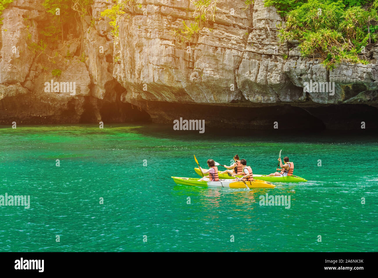 Tourist kayaking in blue Idyllic turquoise ocean to explore near the ...