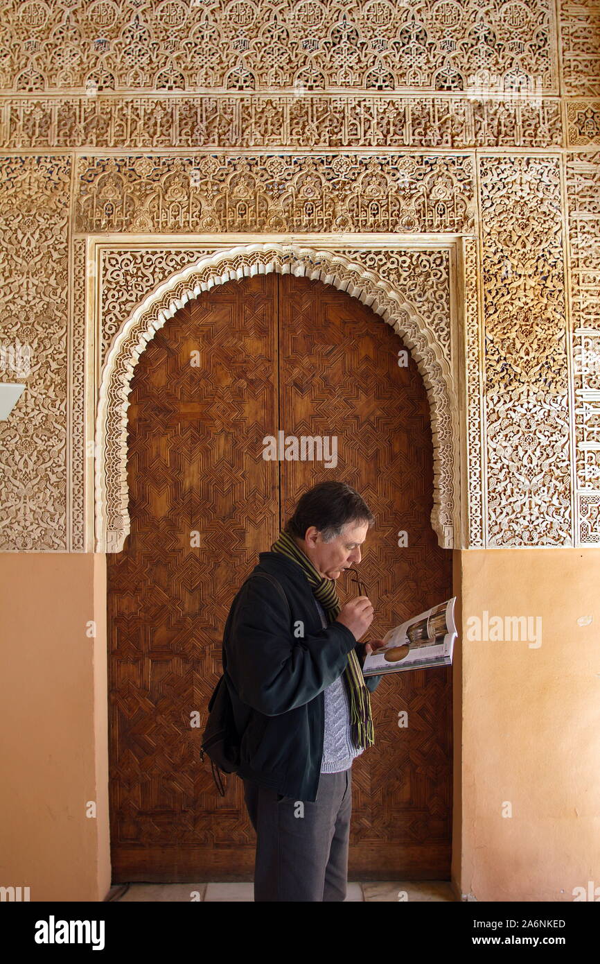 Stucco carving in Arabic script around a doorway in the Alhambra palace ...