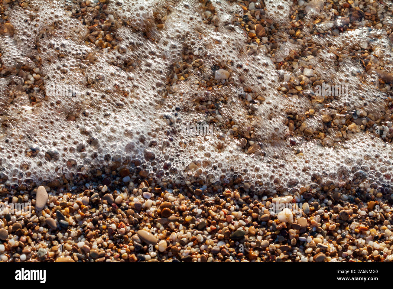 sea pebbles colored granite on the beach background stones. The shore ...