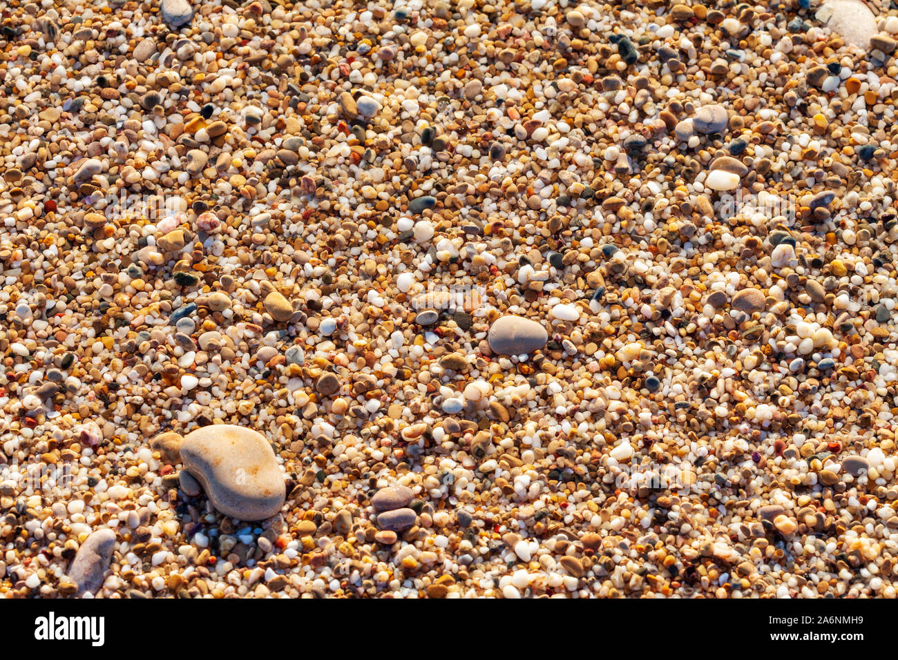 sea pebbles colored granite on the beach background stones. The shore ...