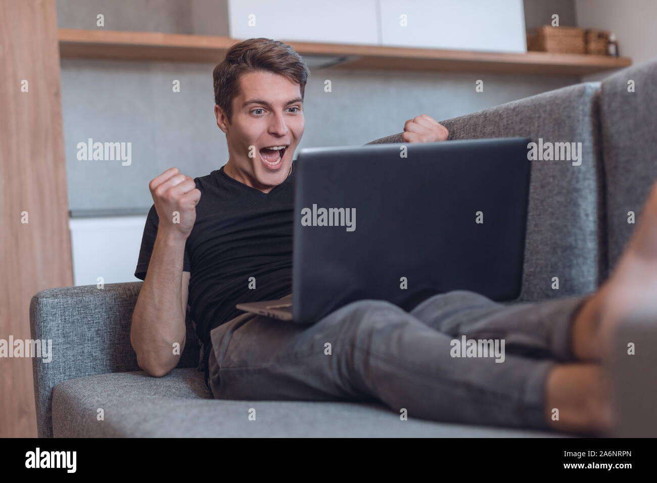 young man watching video on his laptop Stock Photo - Alamy
