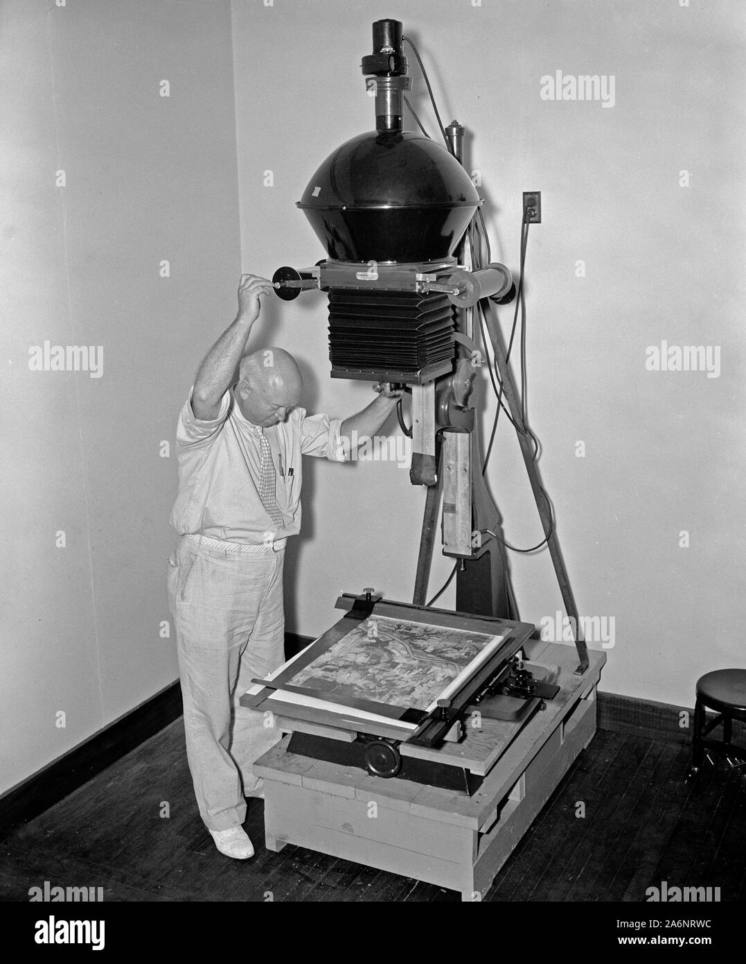 Map making - photographer making prints of a map ca. 1937 Stock Photo ...