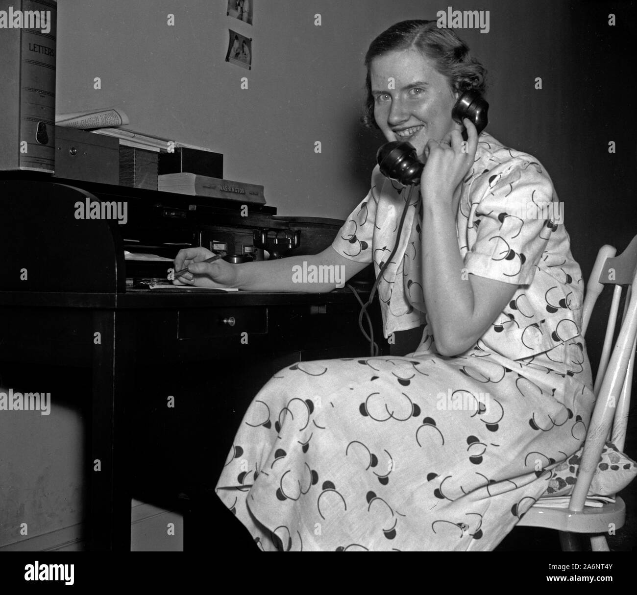 Woman using telephone ca. 1937 Stock Photo - Alamy