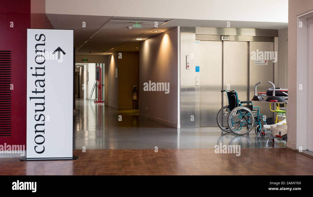 French medical consultation sign in hospital, wheelchair and stretcher ...