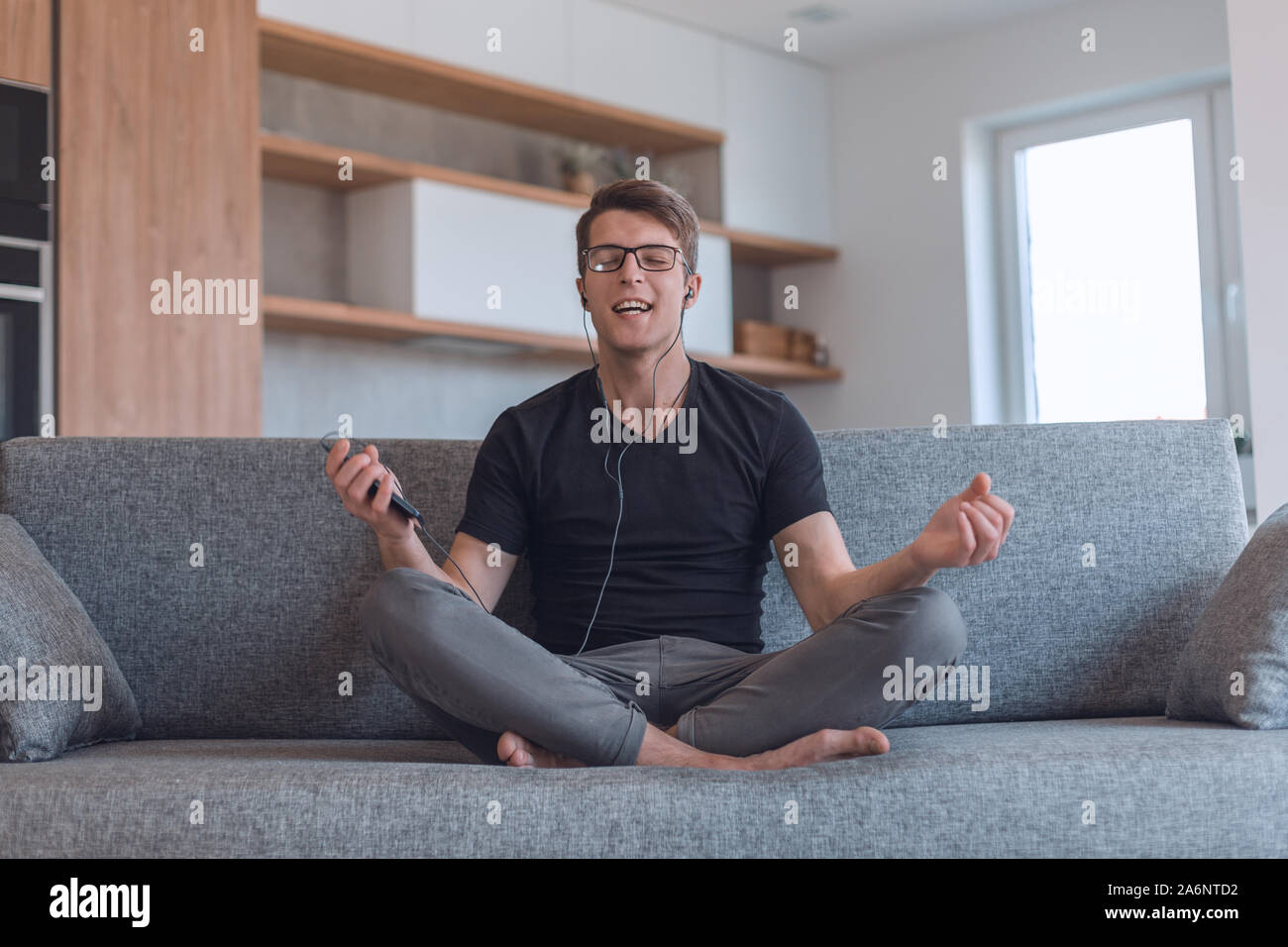 man relaxing to his favorite music, sitting in the Lotus position Stock ...