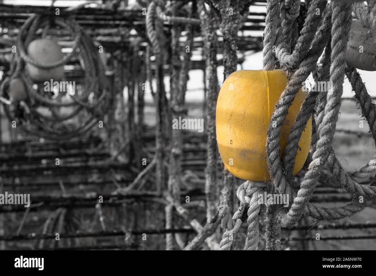 Yellow floater from fishing boat with ropes Stock Photo - Alamy